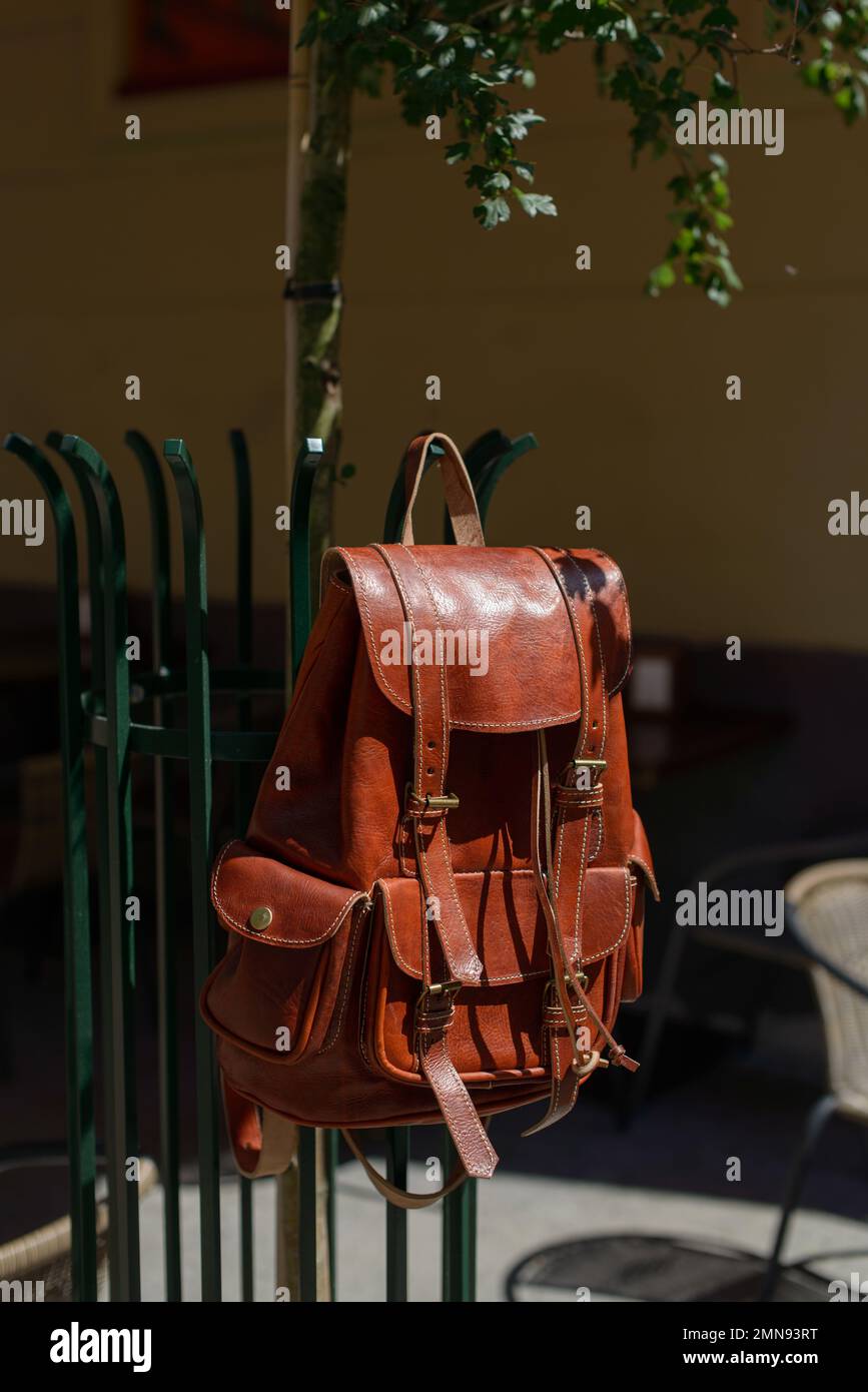 Orange leather oldfashioned backpack on a metal grid Stock Photo - Alamy