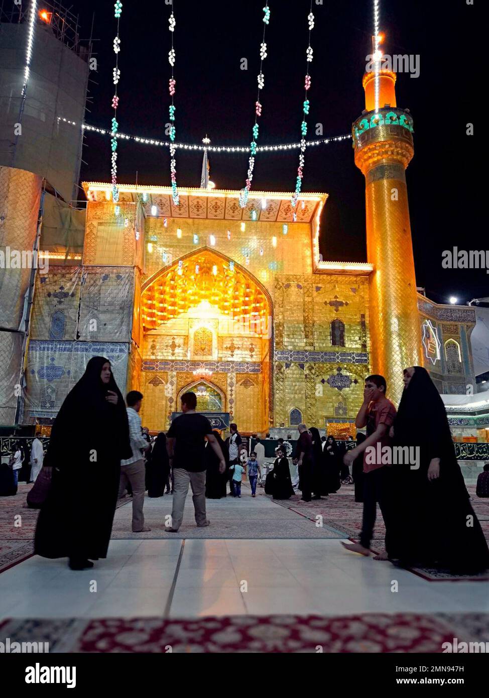 Shiite Muslim worshippers gather outside the holy shrine of Imam Ali ...
