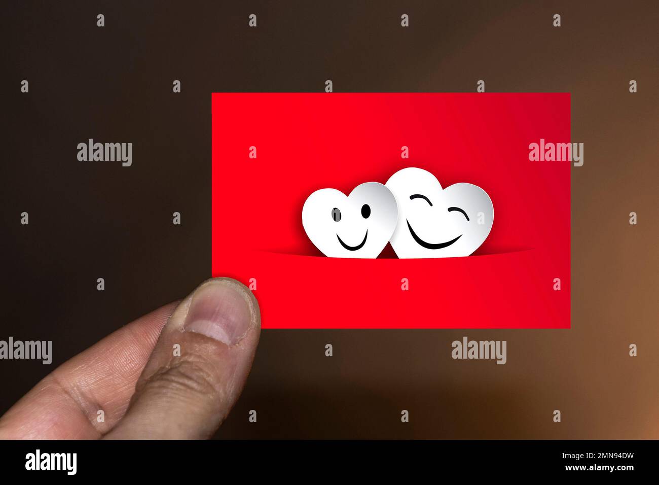 Hand holding card with happy hearts illustration Stock Photo - Alamy