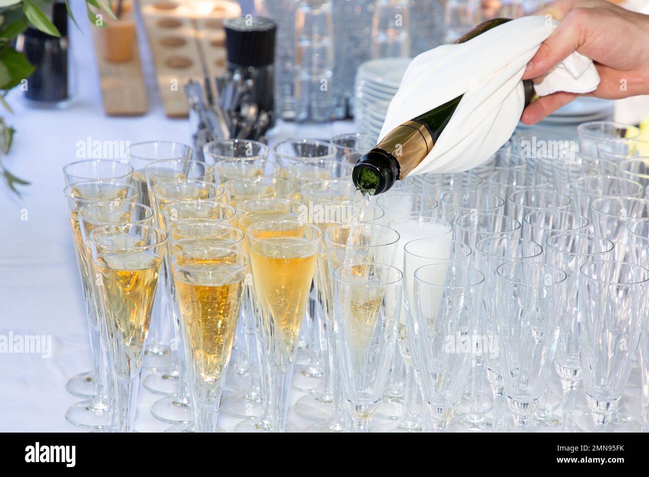 wedding ceremony in the park glass of champagne served outdoor with a ...