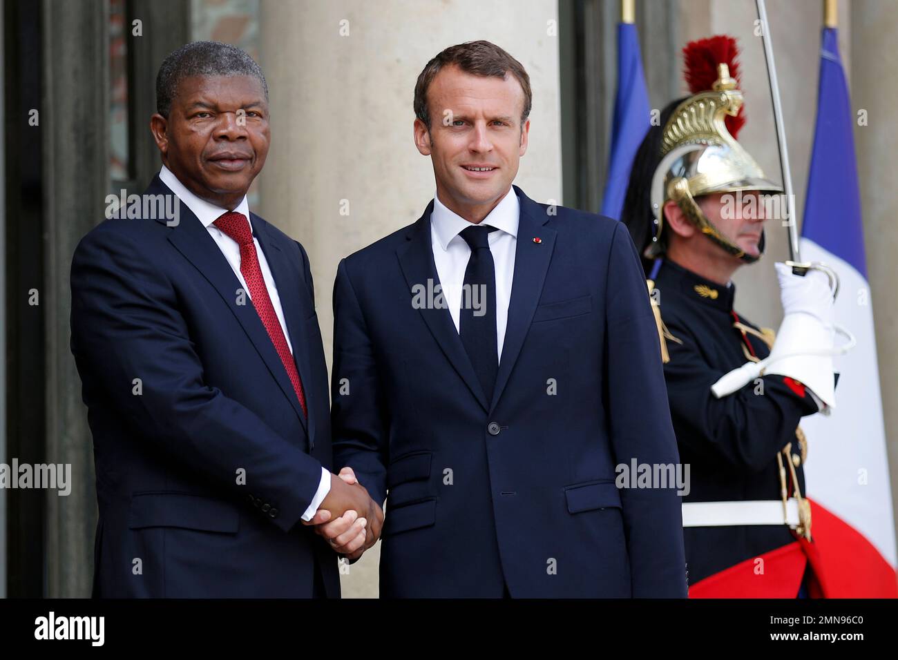 French President Emmanuel Macron, left, welcomes Angola's President ...
