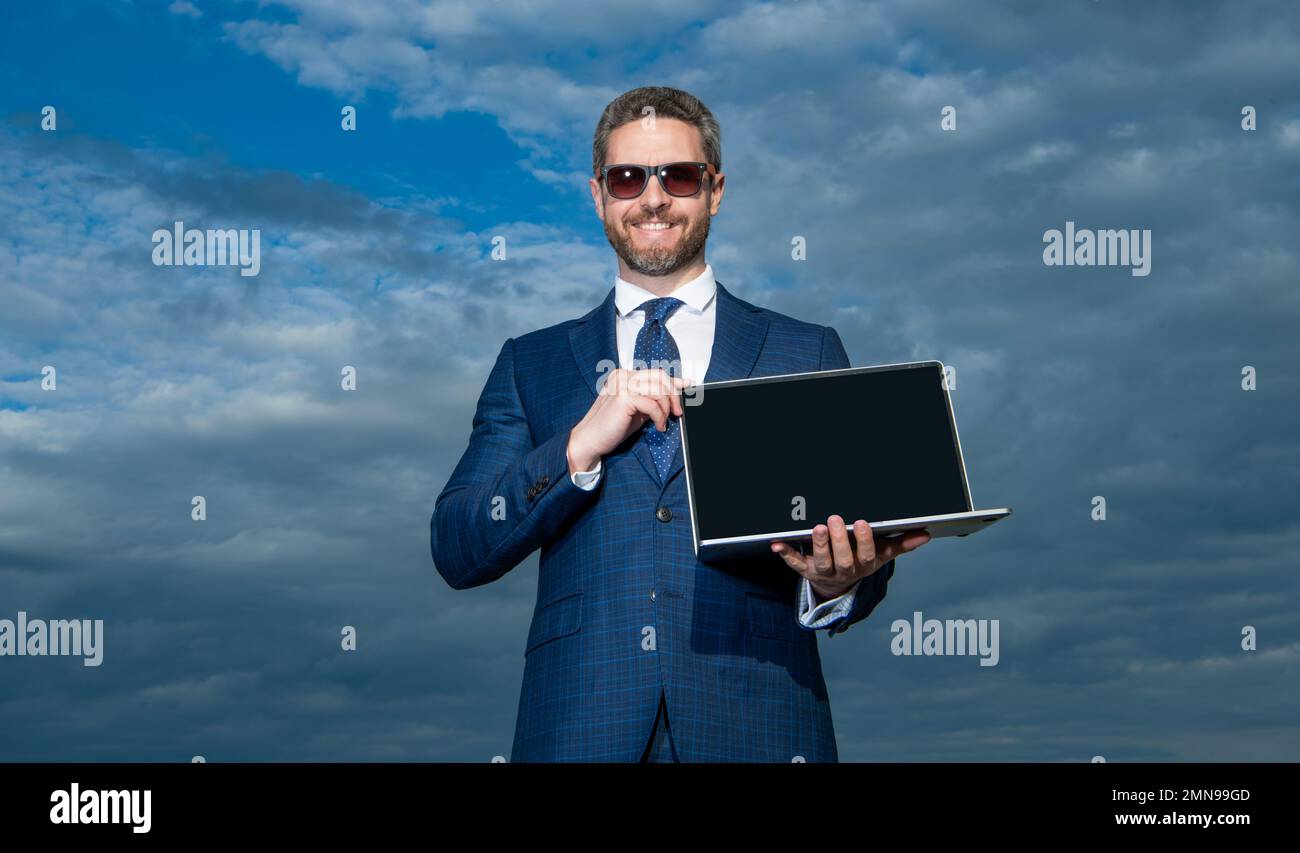 Happy man developer showing open laptop. Successful desktop developer ...