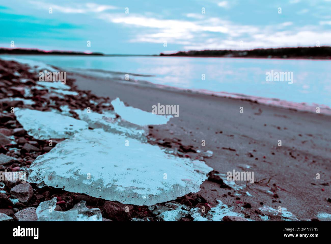 Small glaciers of the first ice lie on the sandy bank of the Vilyui ...