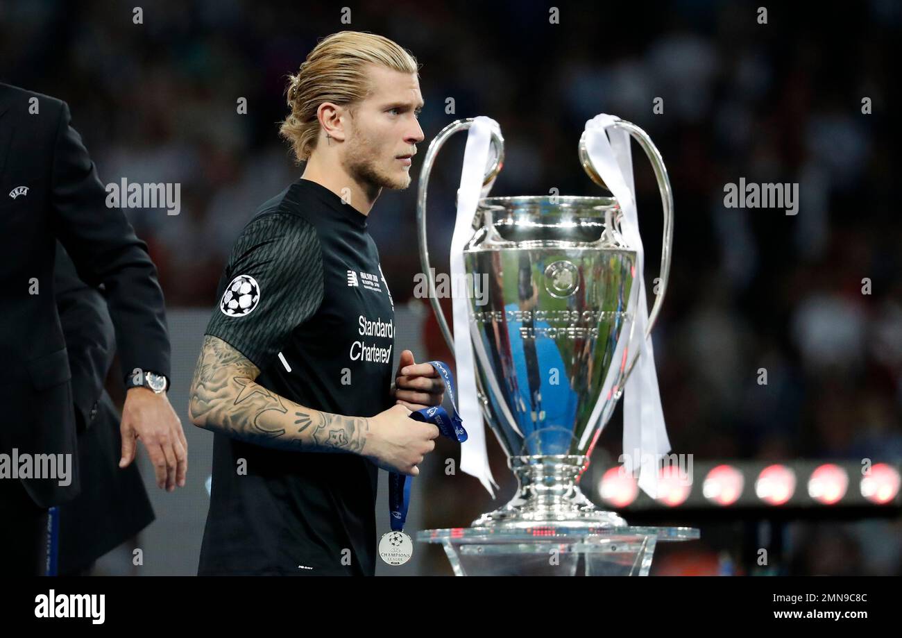 Liverpool goalkeeper Loris Karius walks past the trophy after the ...