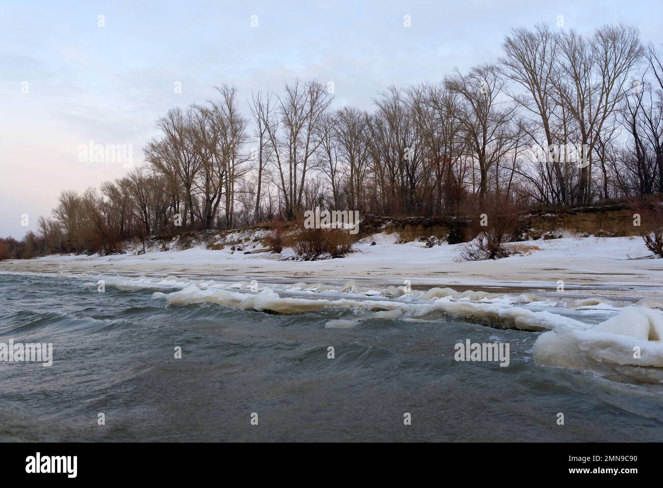 The first weak autumn ice rises in waves from the flow of water near ...