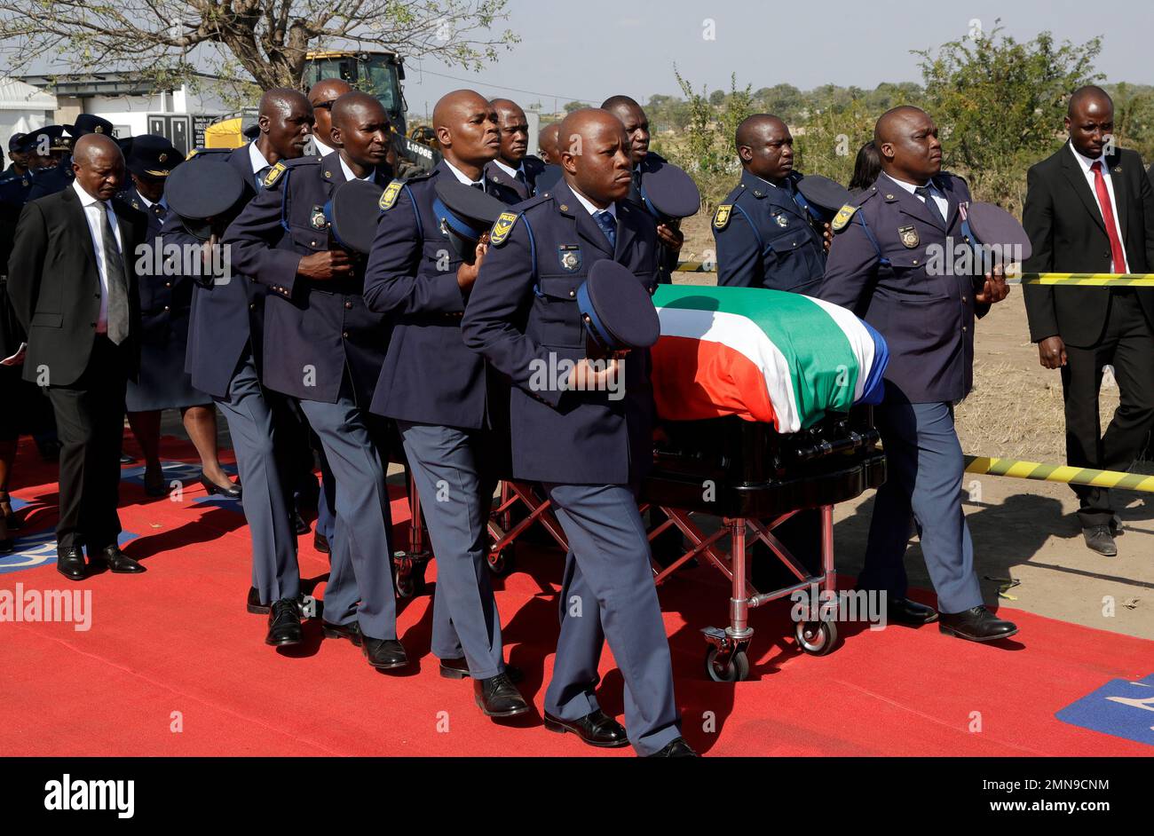 South African police pallbearers carry a coffin of photographer, Sam ...