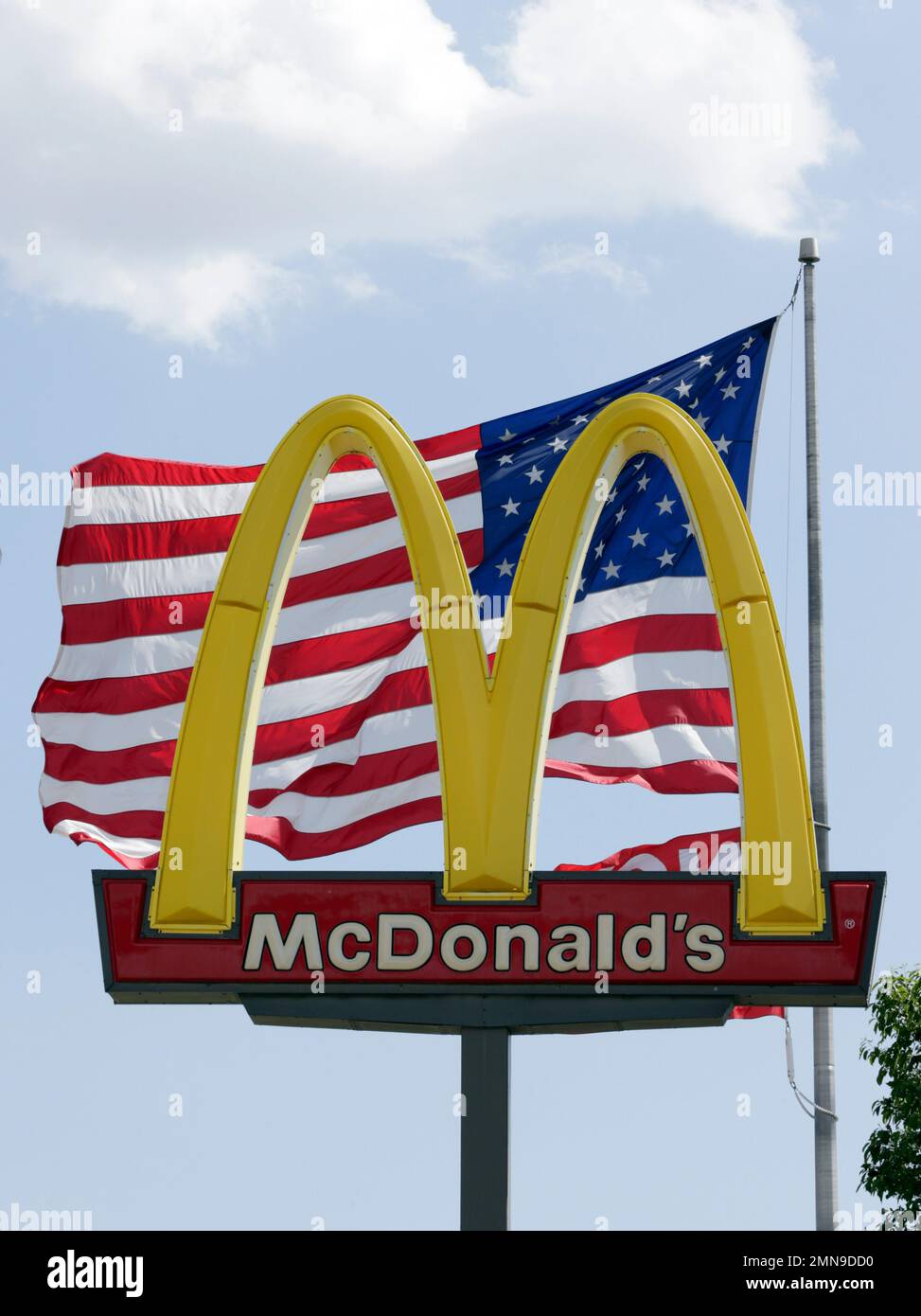 A flag flies behind the golden arches of a McDonald's restaurant in La ...