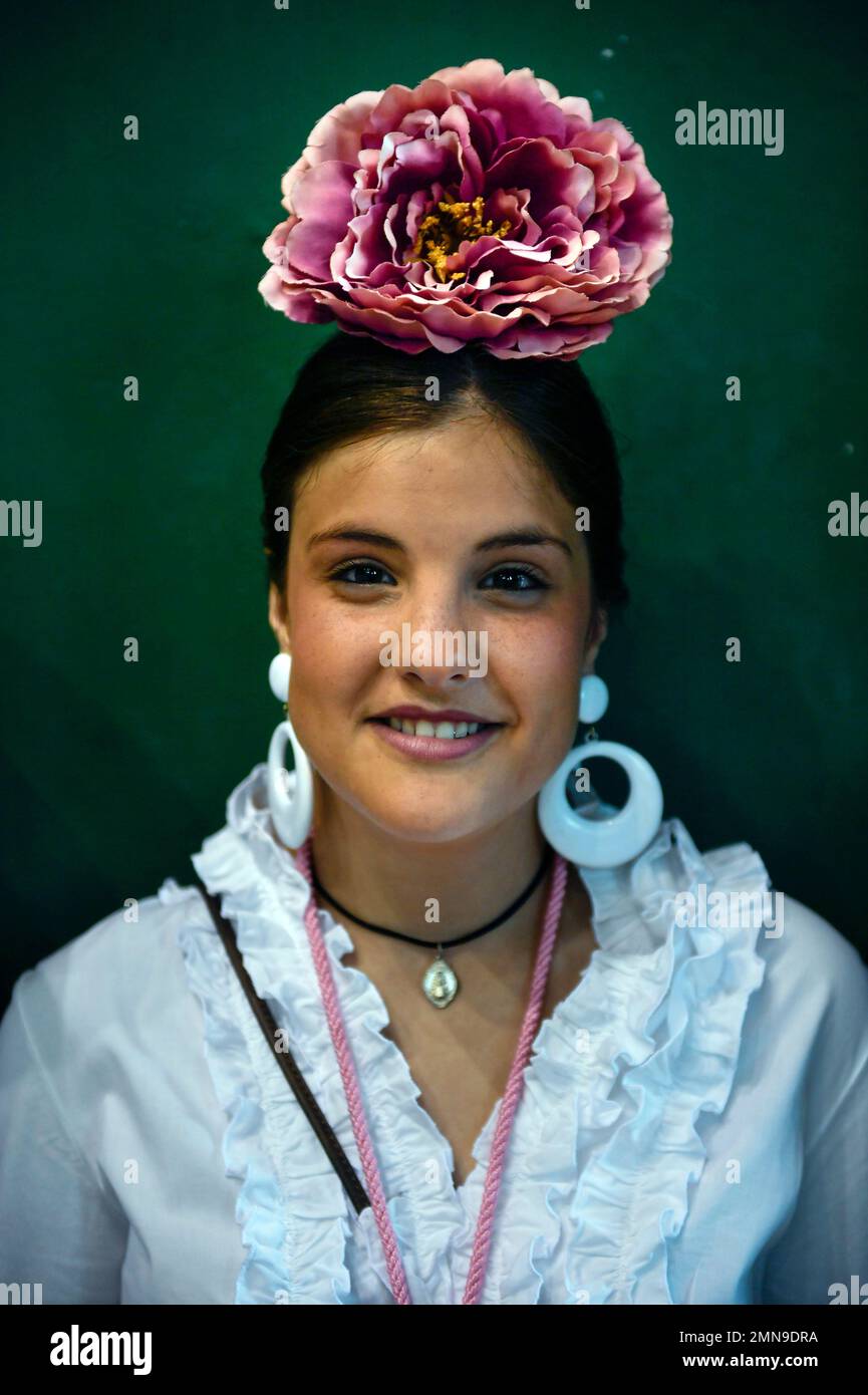 A devotee of the Rocio Virgin poses for a photo as she takes part in ...