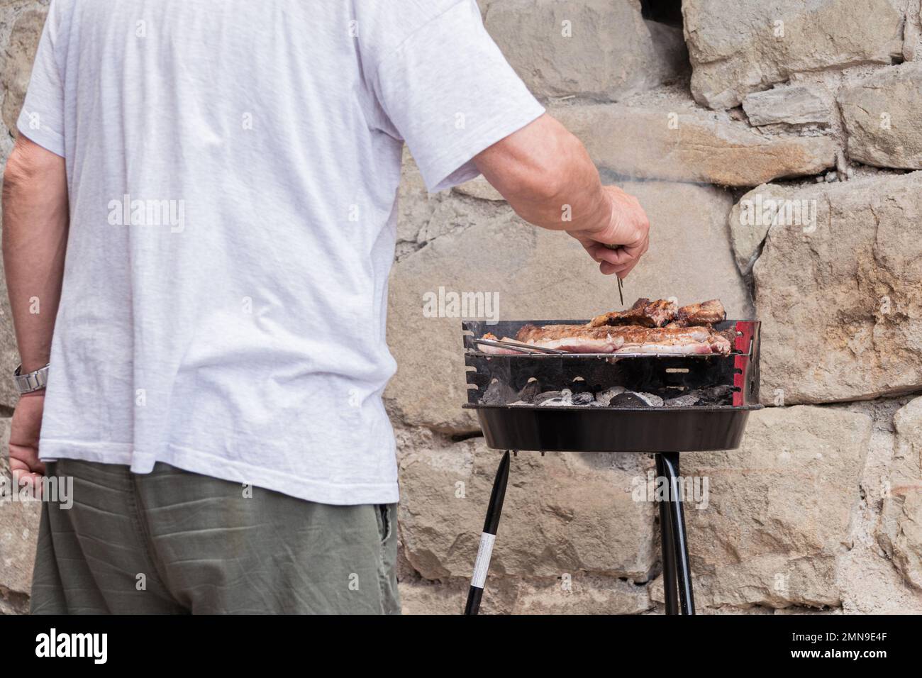 Rear view man cooking hi-res stock photography and images - Alamy