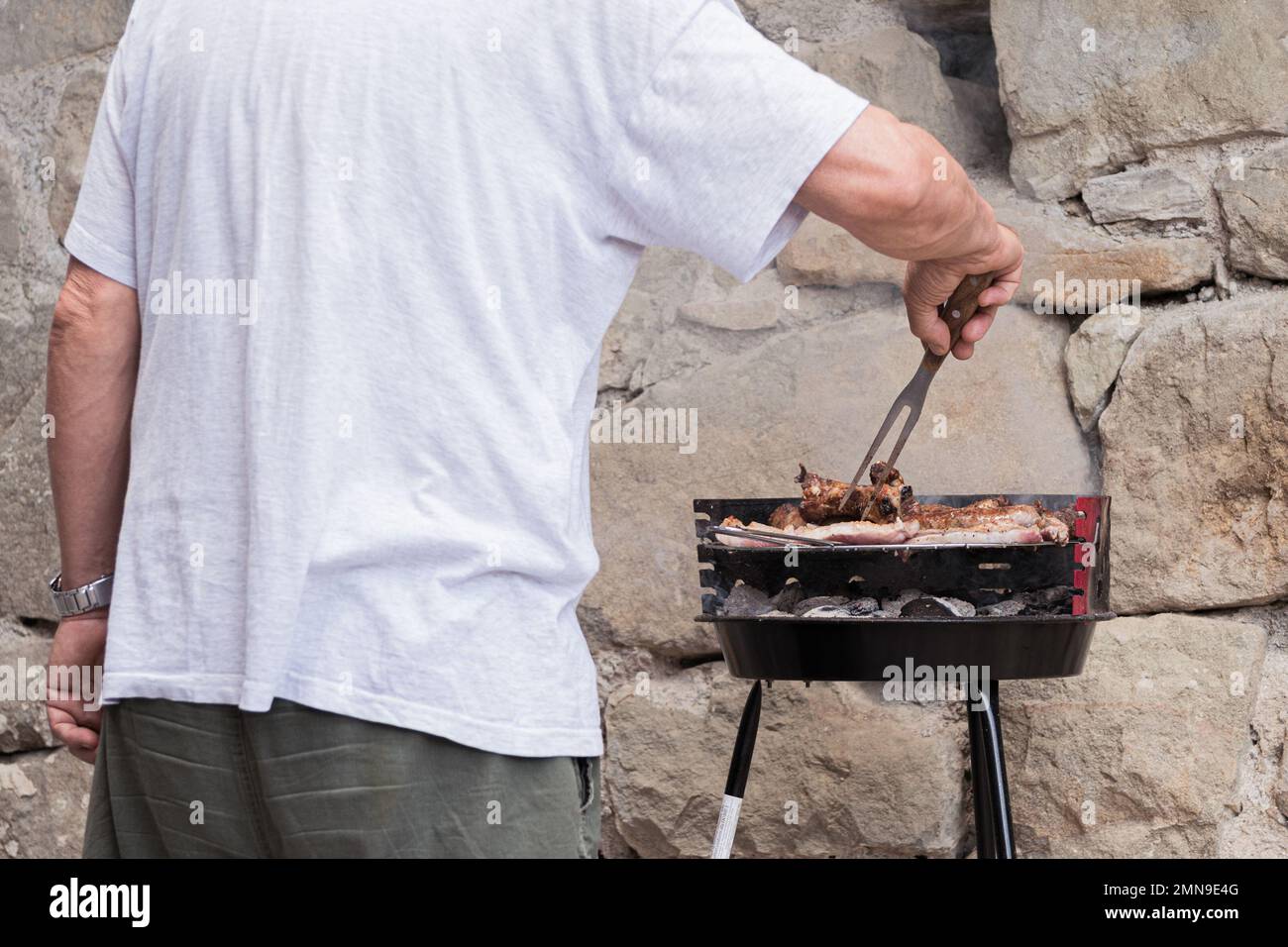 Chicken male adult barbecue cooking hi-res stock photography and images ...