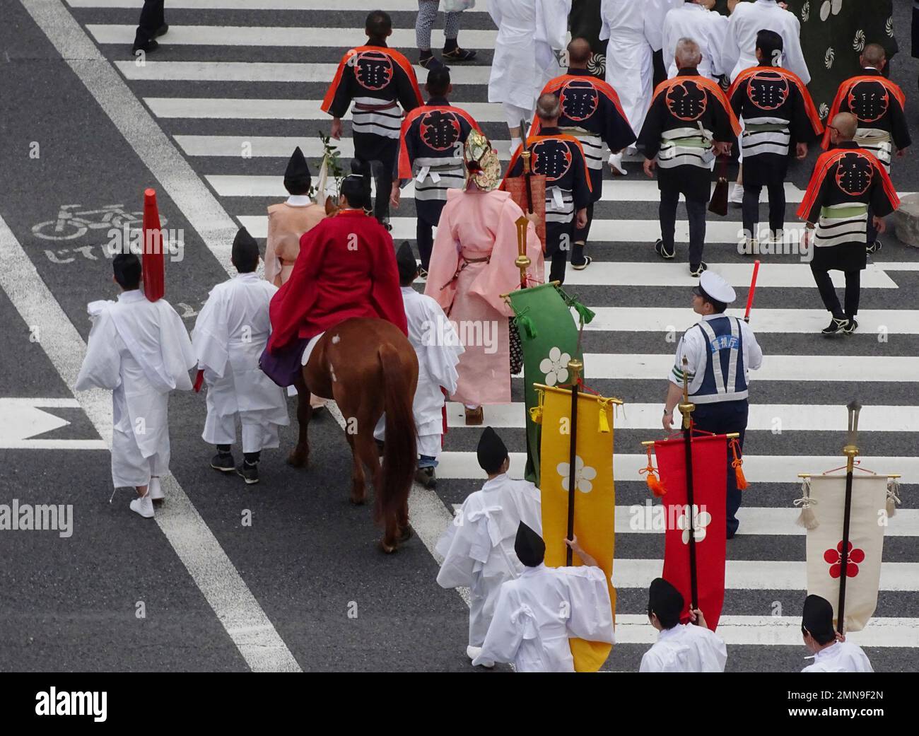 Participants parade on a street during Yushima Tenman Shrine annual ...