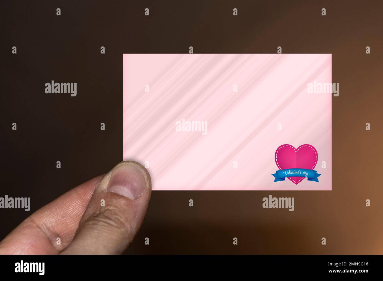 Hand with decorated card for Valentine's Day Stock Photo - Alamy