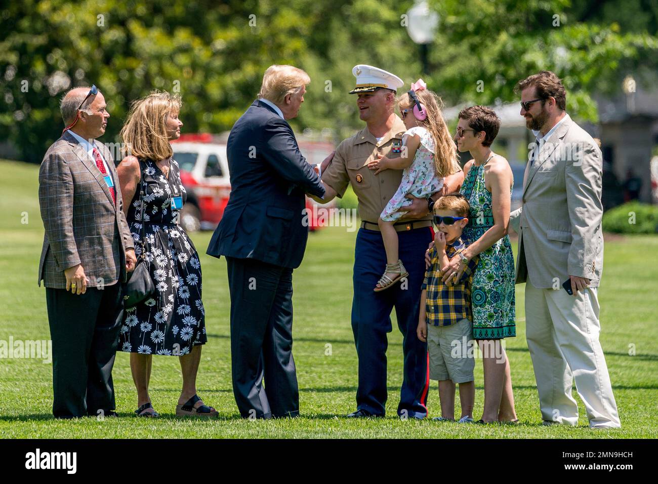 President Donald Trump, third from left, shakes hands with Marine One ...