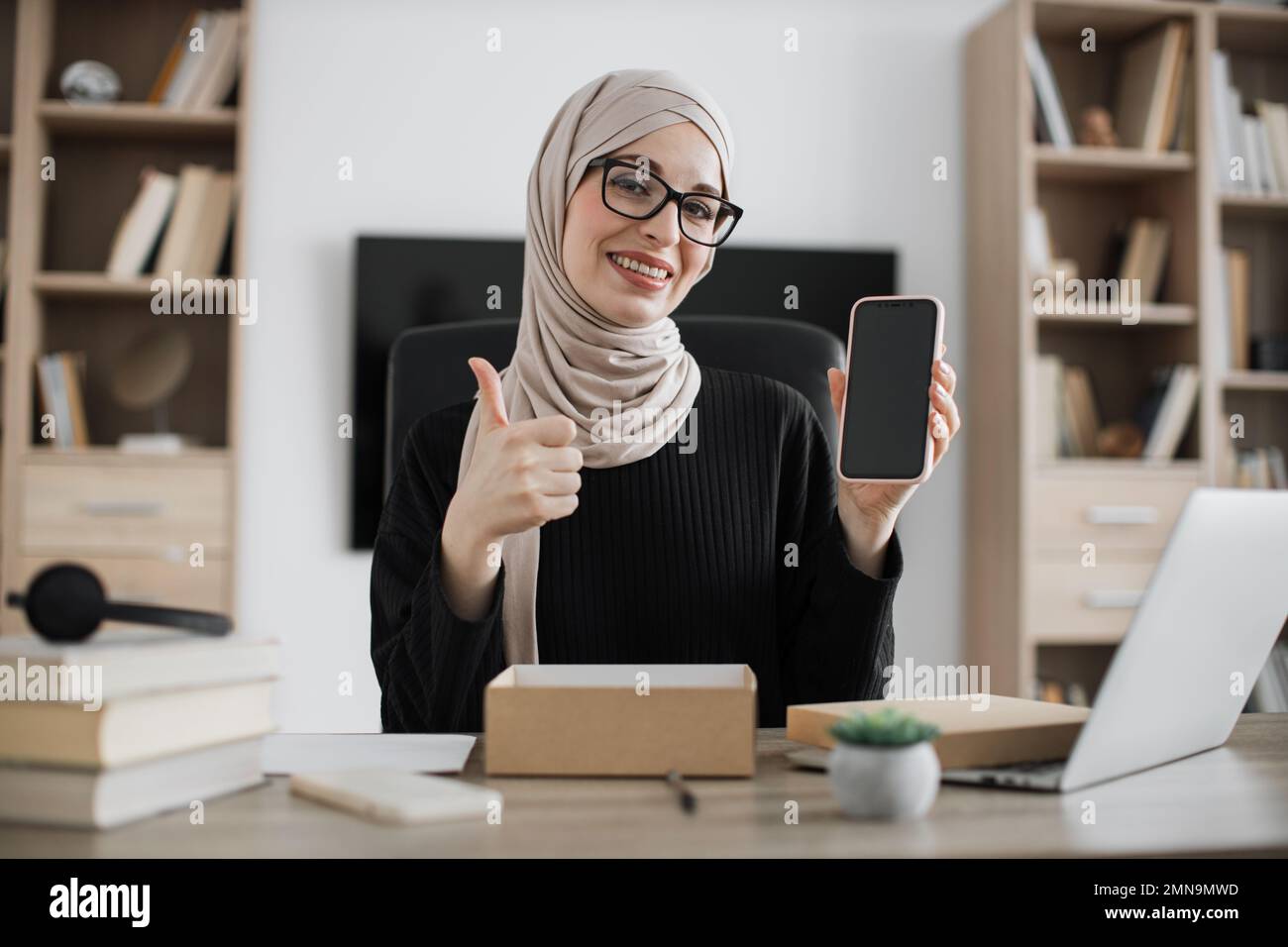 Arabian female blogger sharing her feedback about modern gadget with ...