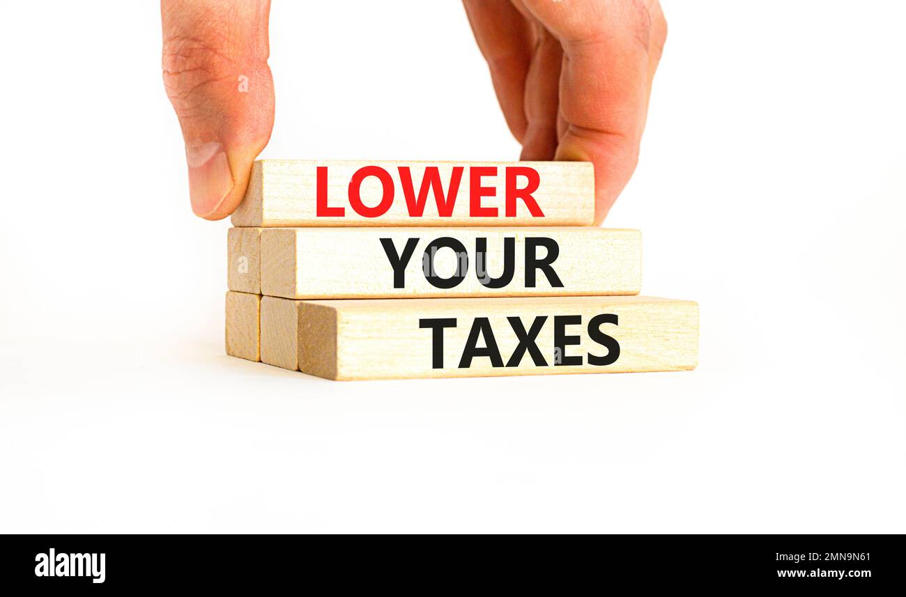 Lower your taxes symbol. Concept words Lower your taxes on wooden ...