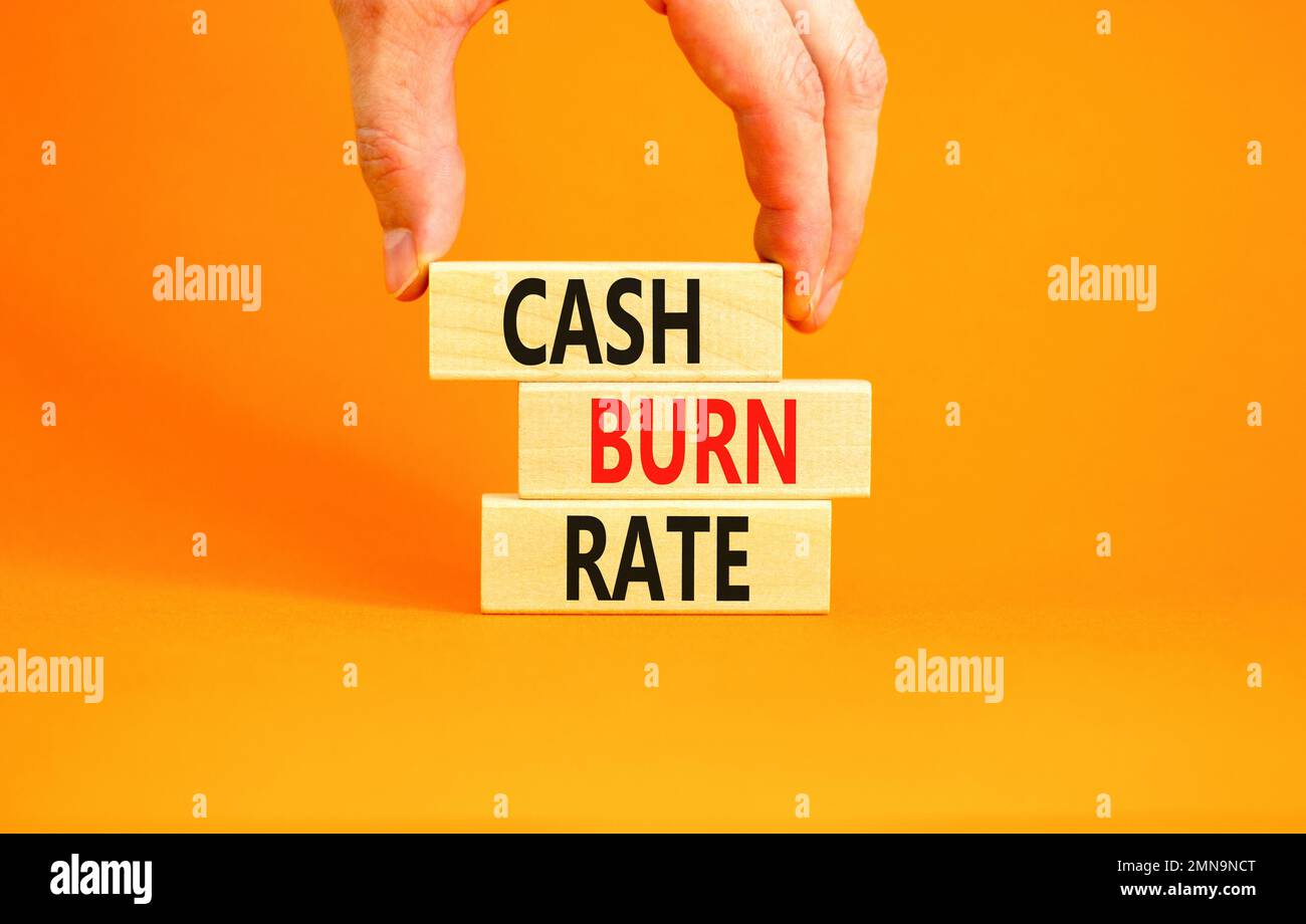 Cash burn rate symbol. Concept words Cash burn rate on wooden blocks on ...