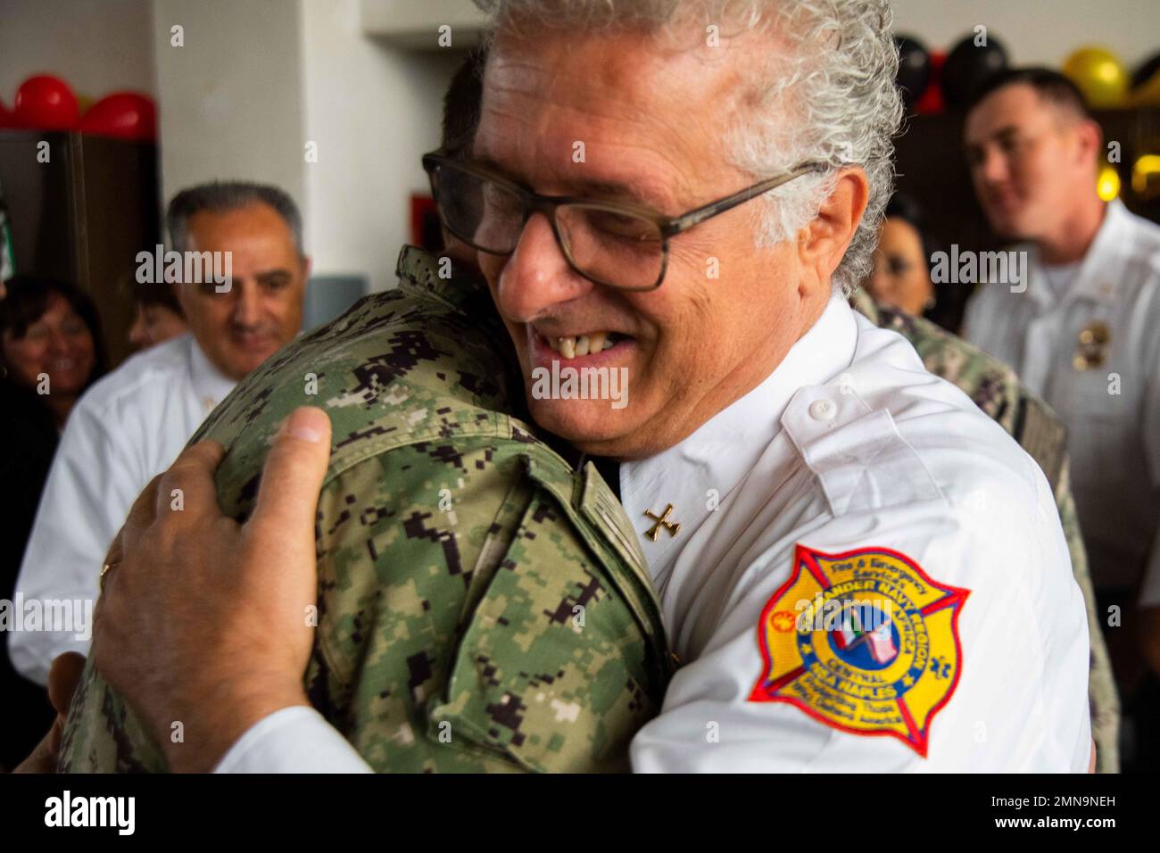 NAPLES, ITALY –– Italian Fire Chief Giovanni Rippa hugs a Sailor after ...