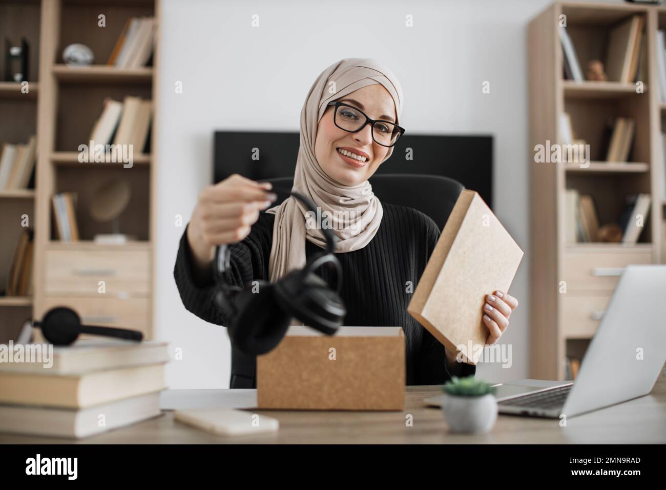 Arabian female blogger sharing her feedback about modern gadget with ...