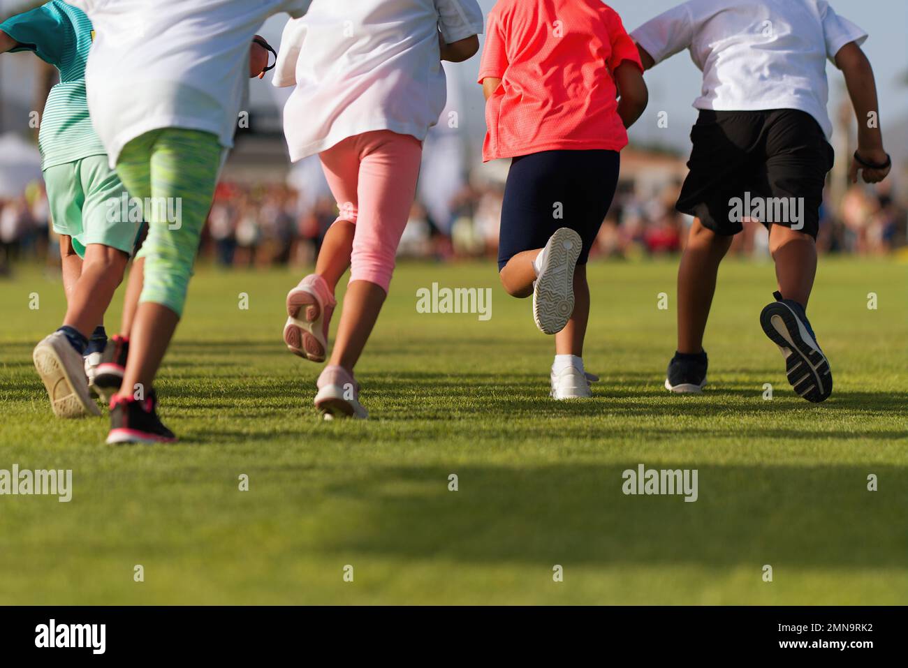 Running children, young athletes run in a kids run race, running on ...