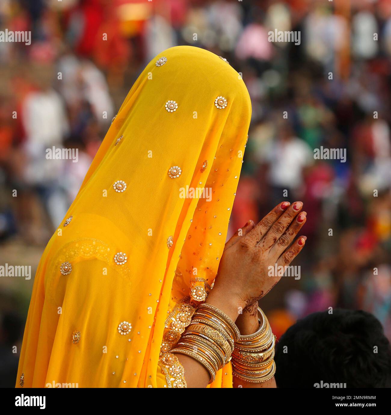 A Hindu devotee offers prayers in the Rivers Ganges on Ganga Dussehra ...