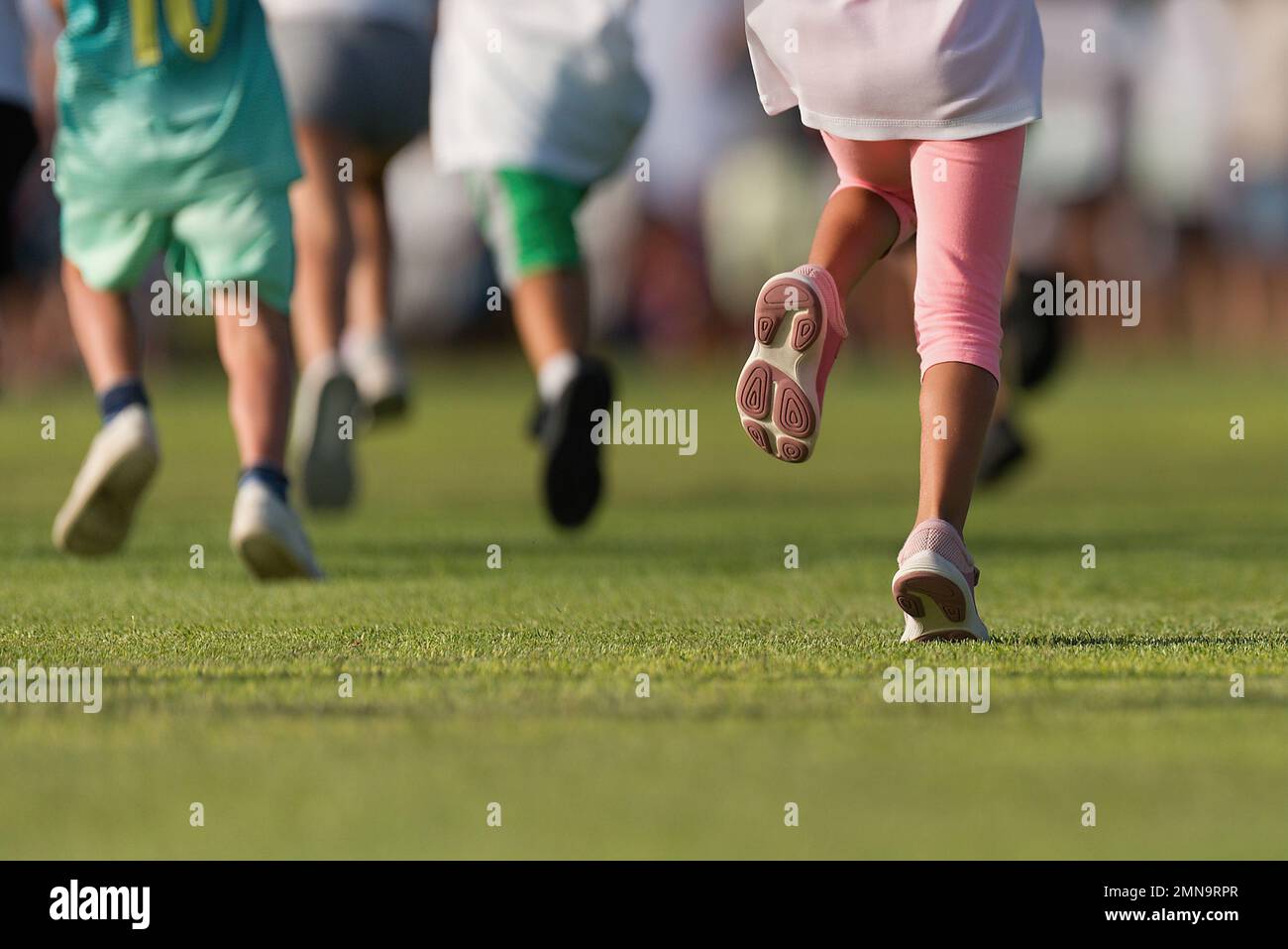 Running children, young athletes run in a kids run race, running on ...