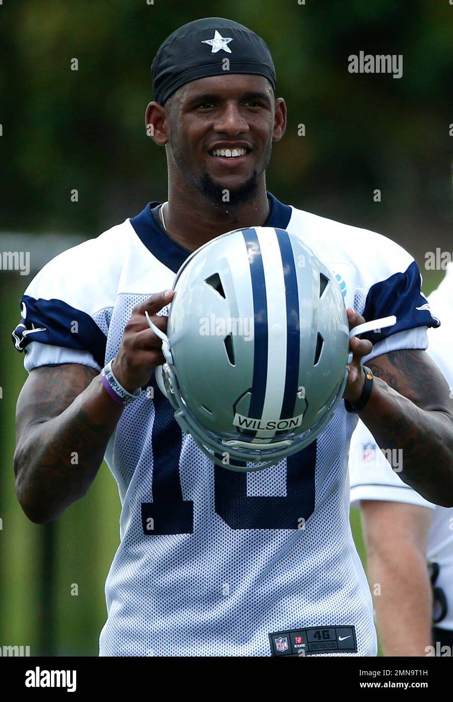 Dallas Cowboys wide receiver Ced Wilson (16) puts on his helmet during ...