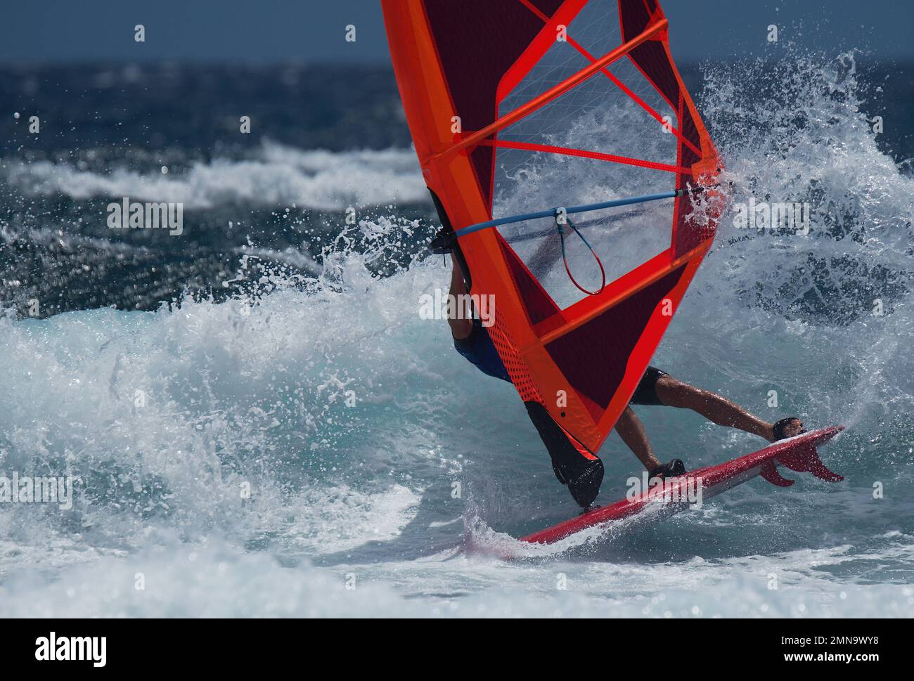 Professional windsurfer riding high waves at sunny windy day Stock ...