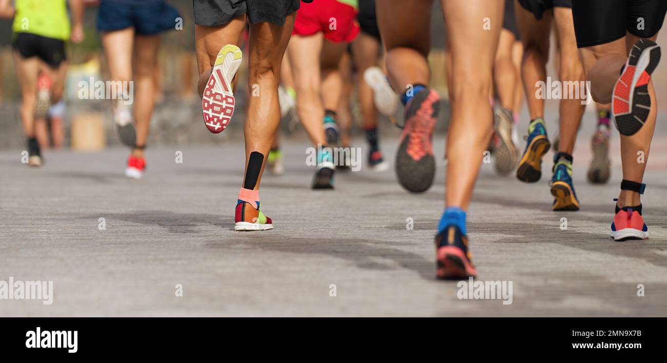 Marathon running race, people feet on city road Stock Photo - Alamy