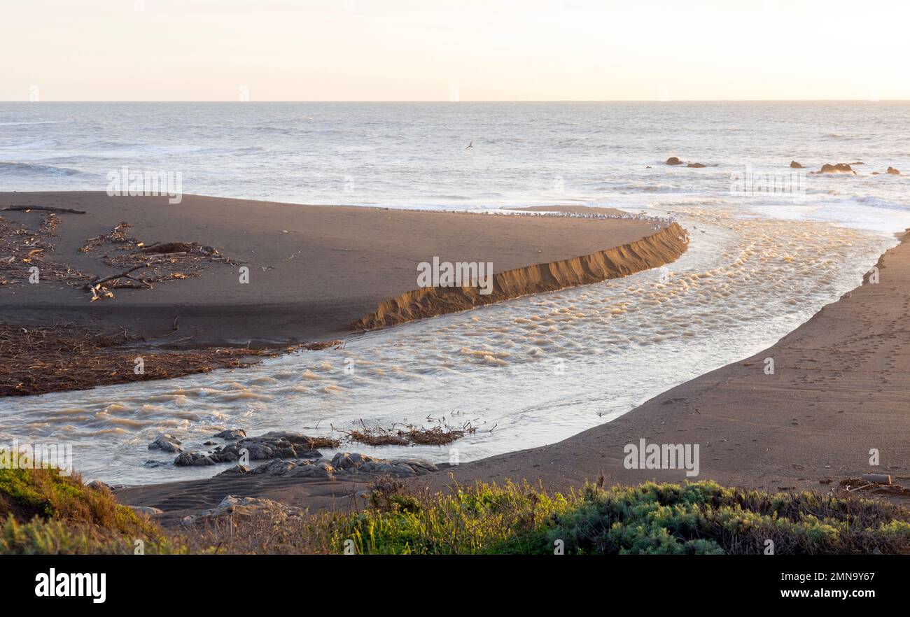 Beach erosion by fresh water overflow Stock Photo - Alamy