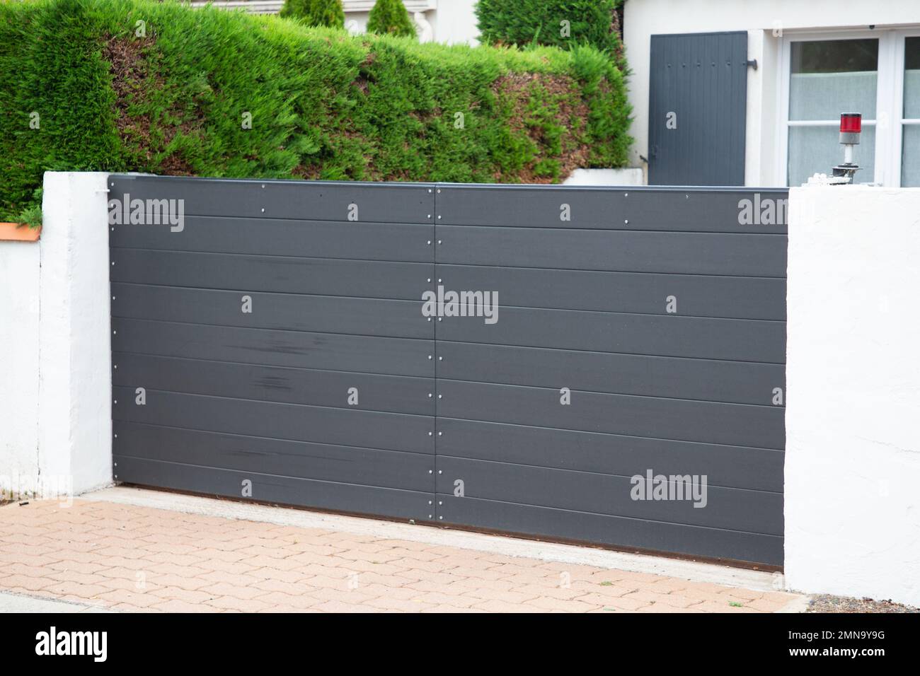 steel sliding high grey metal gate on modern house street Stock Photo ...
