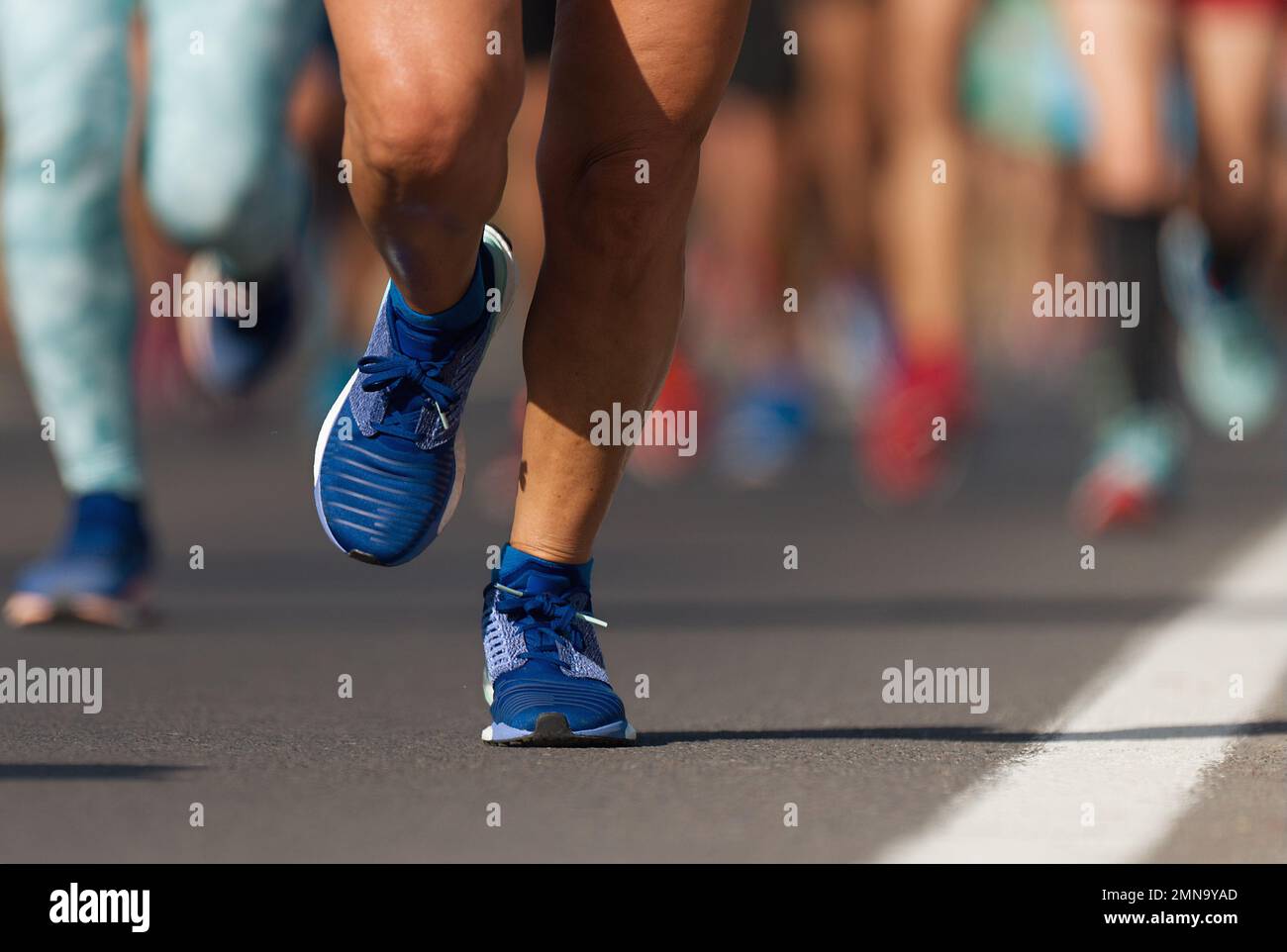 Marathon running race, people feet on city road Stock Photo - Alamy