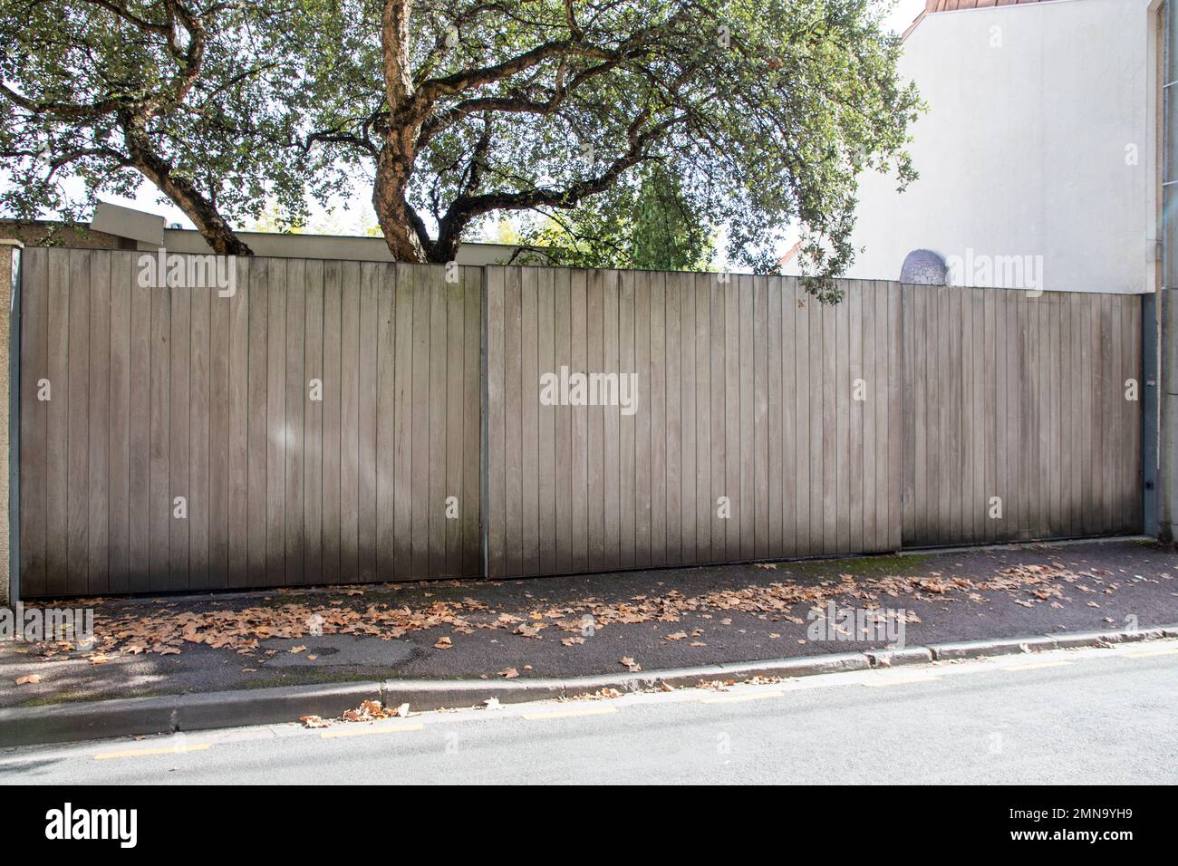 entry wooden gate high long closed of private house suburb wood portal ...