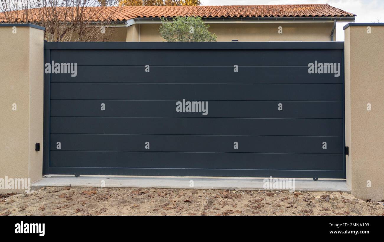 door high dark gray metal gate to house with portal black to access ...