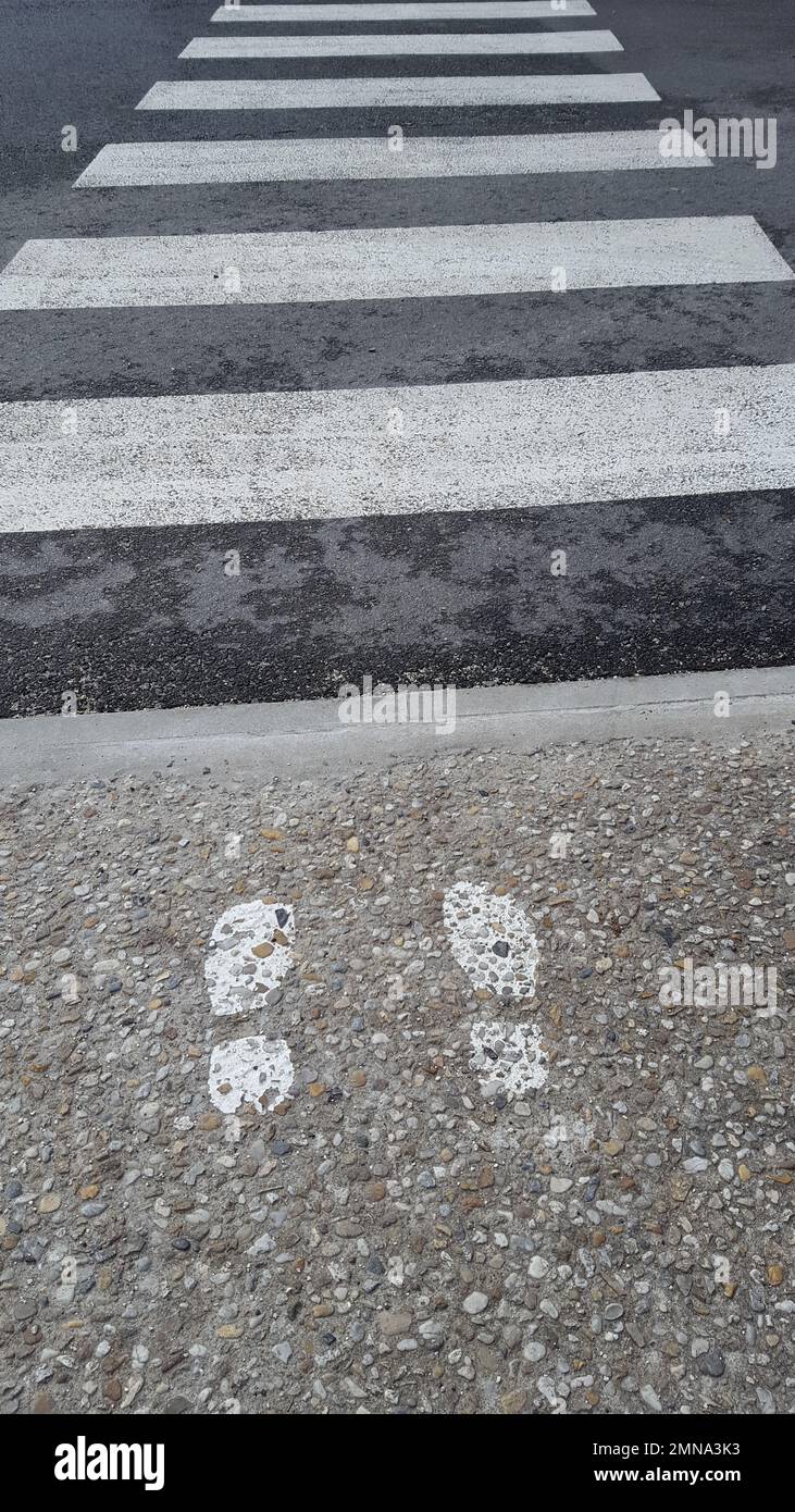 white pedestrian crossing with footprint road markings feet Stock Photo ...