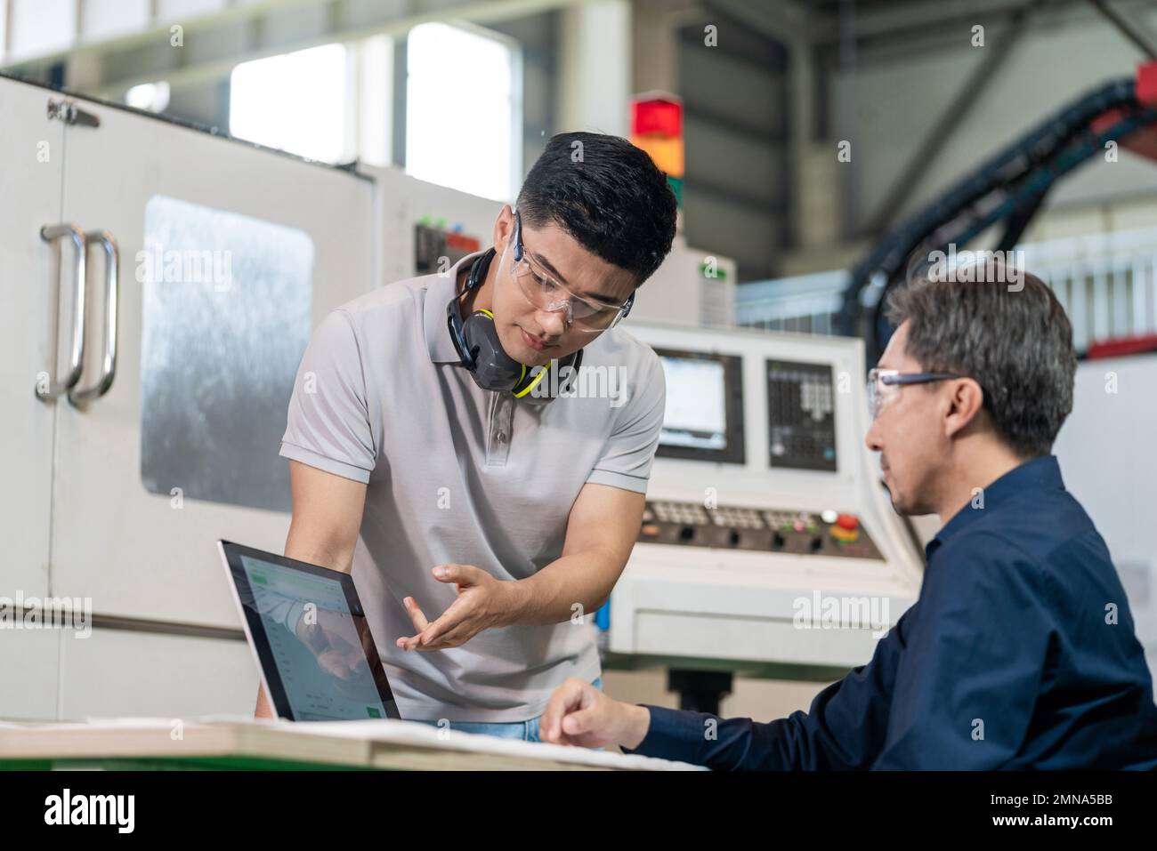 Engineers working in the factory Stock Photo - Alamy