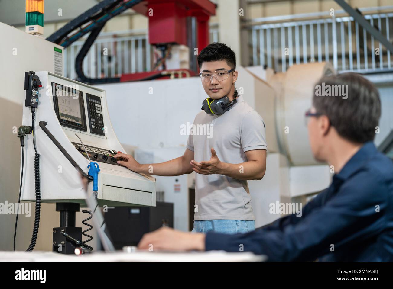 Engineers working in the factory Stock Photo - Alamy