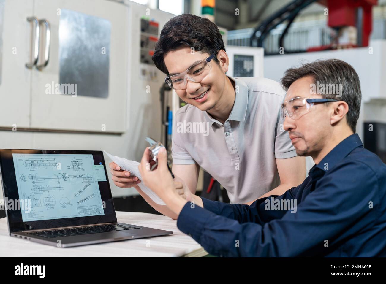 Engineers working in the factory Stock Photo - Alamy