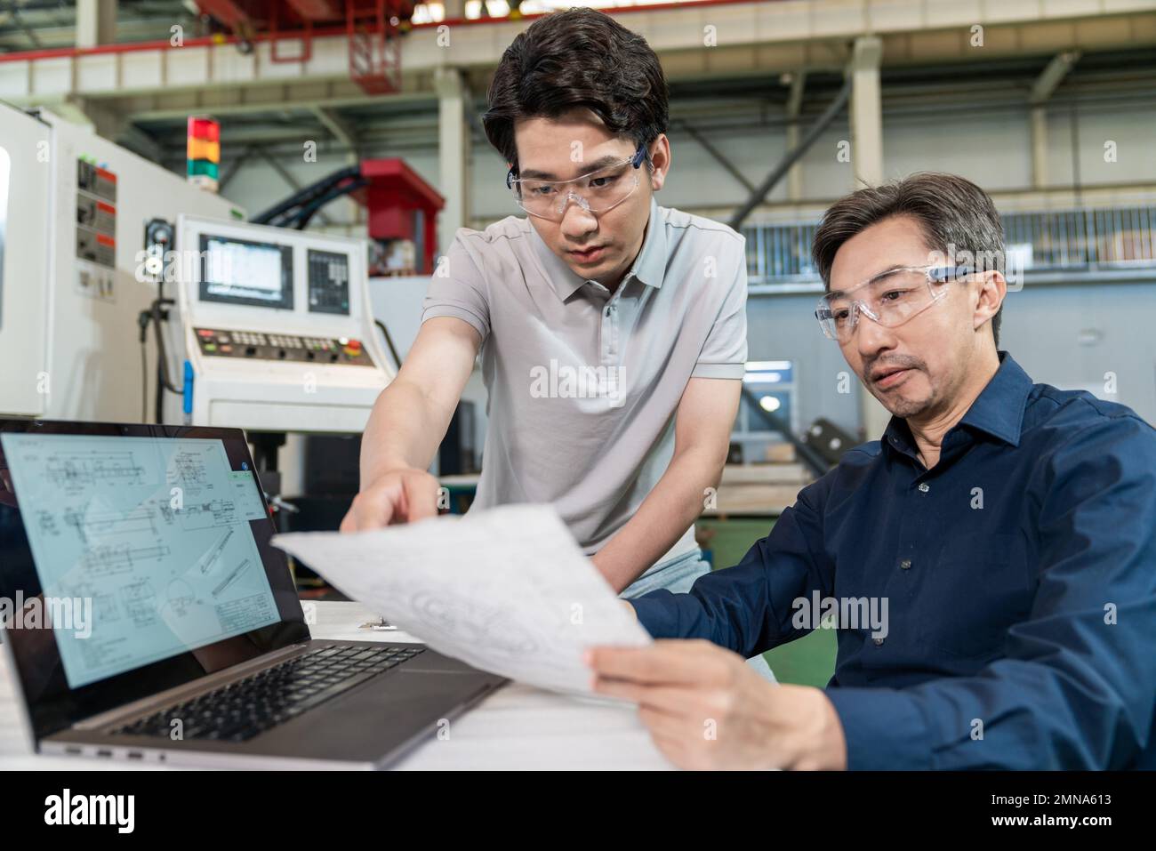 Engineers working in the factory Stock Photo - Alamy