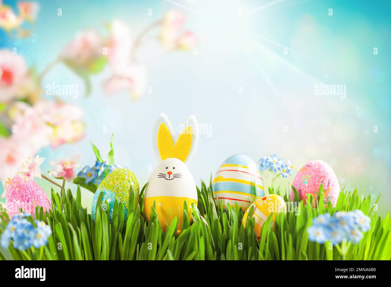 Easter eggs and spring flowers on meadow. Easter concept. Spring or ...