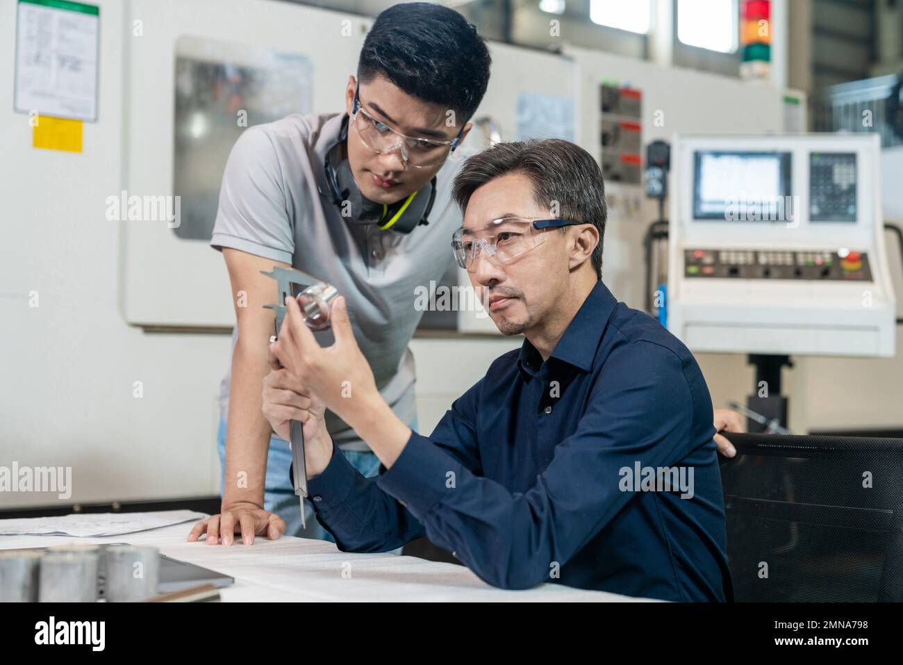 Engineers working in the factory Stock Photo - Alamy