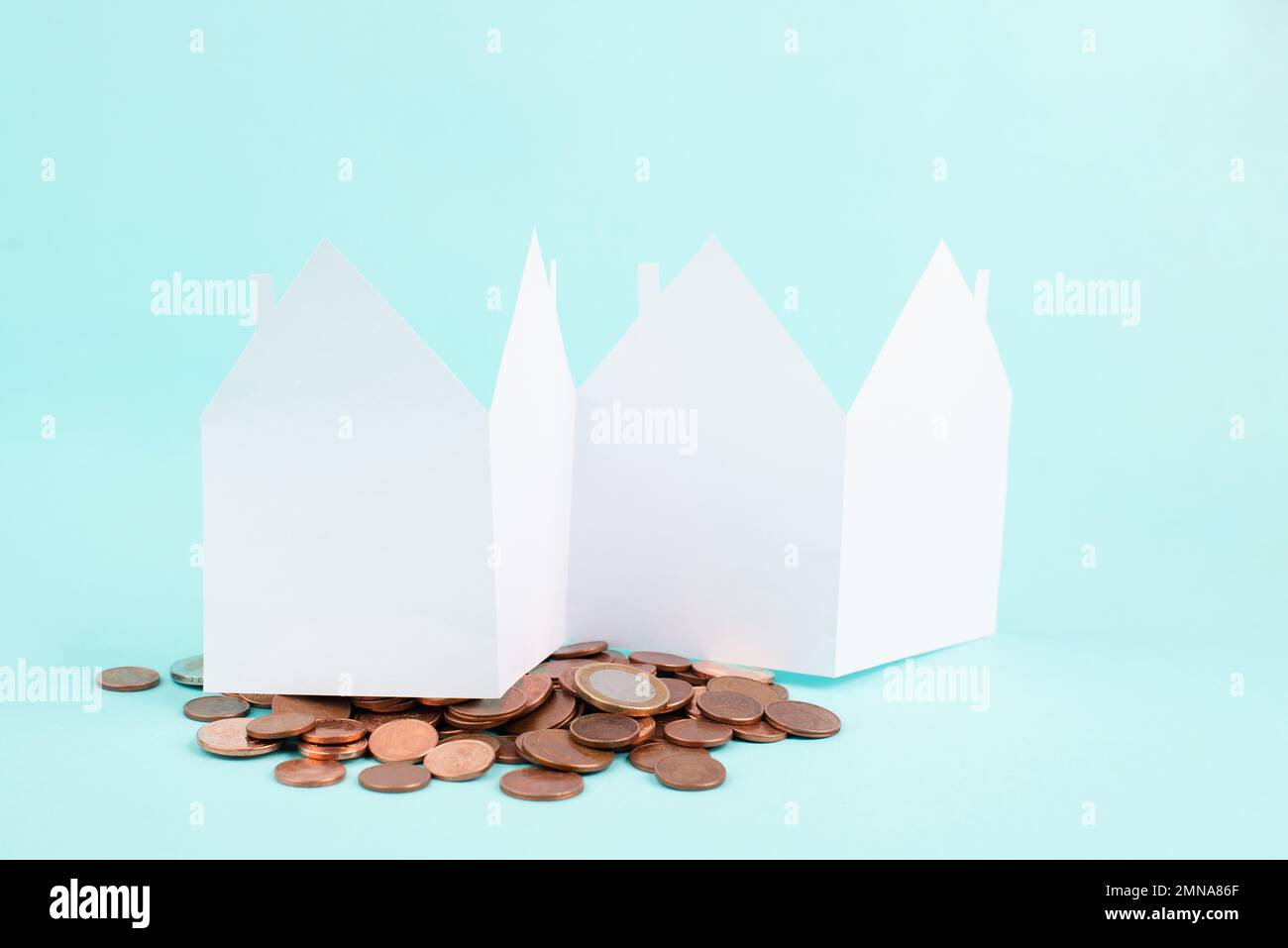 Paper house with Cent coins, planning to buy, build or rent a new home ...