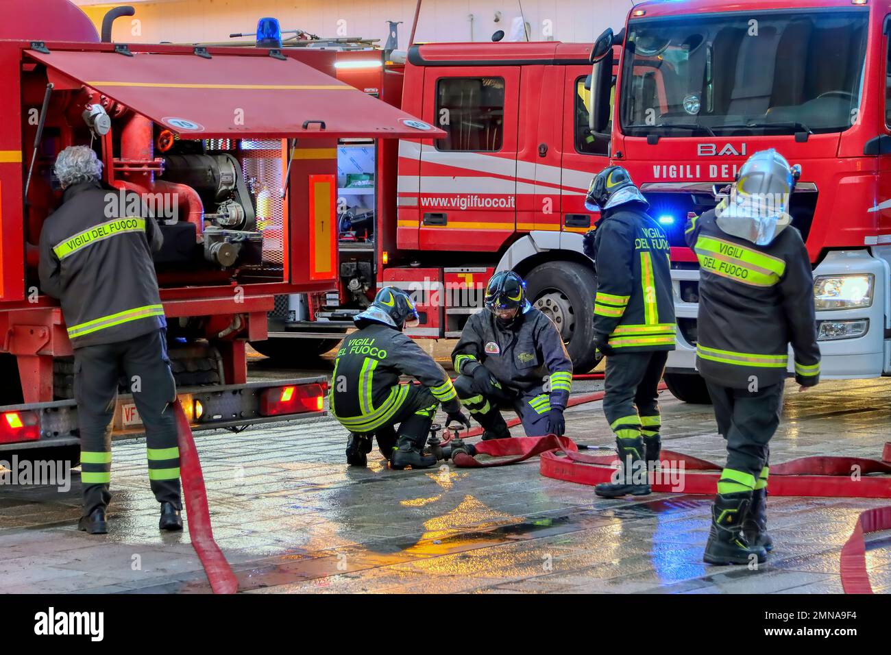 Italian firefighters at work during a fire in an attic of a building in ...