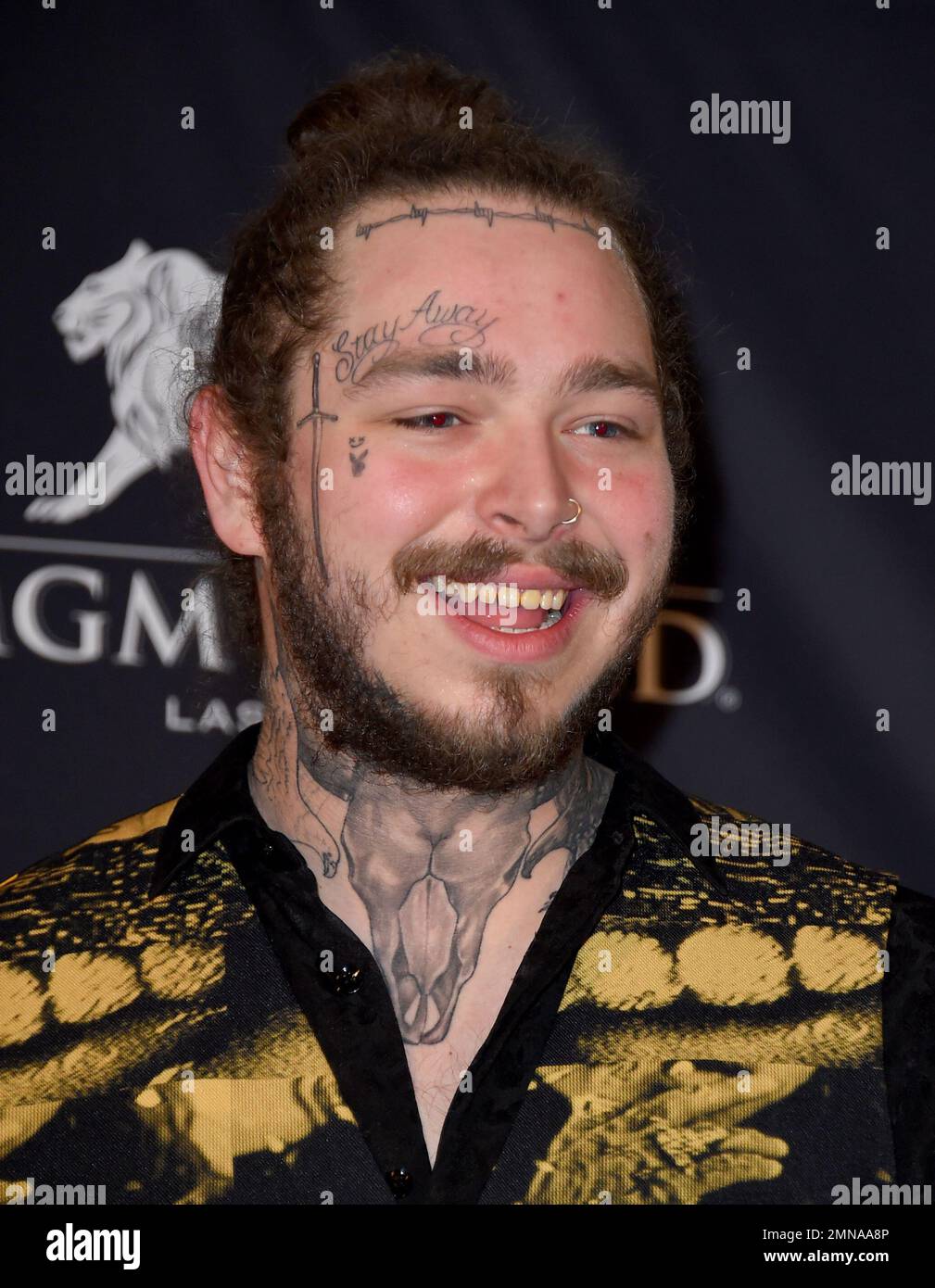 Post Malone poses in the press room with the award for top rap song for ...