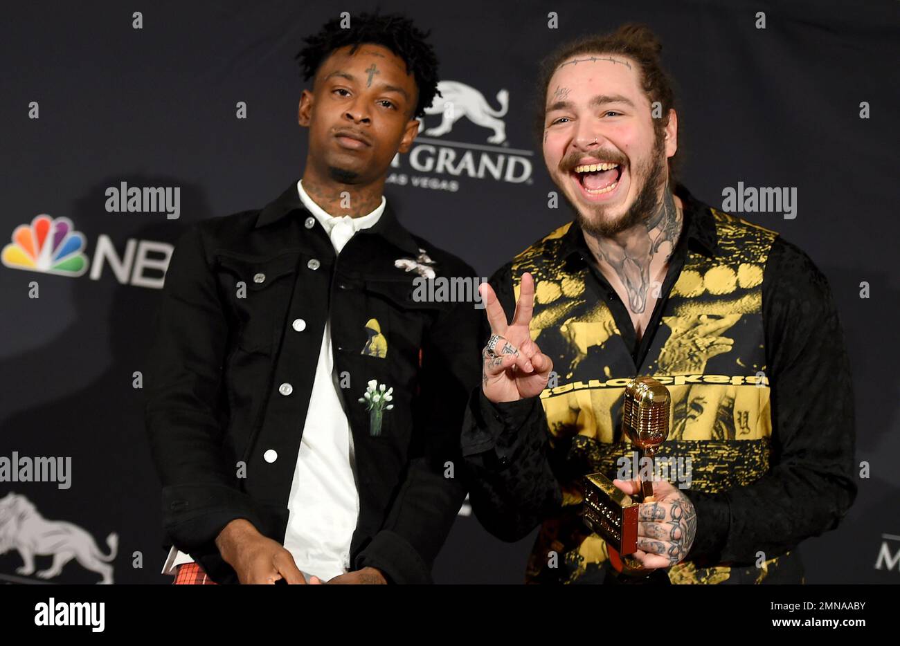 21 Savage, left, and Post Malone pose in the press room with the award ...