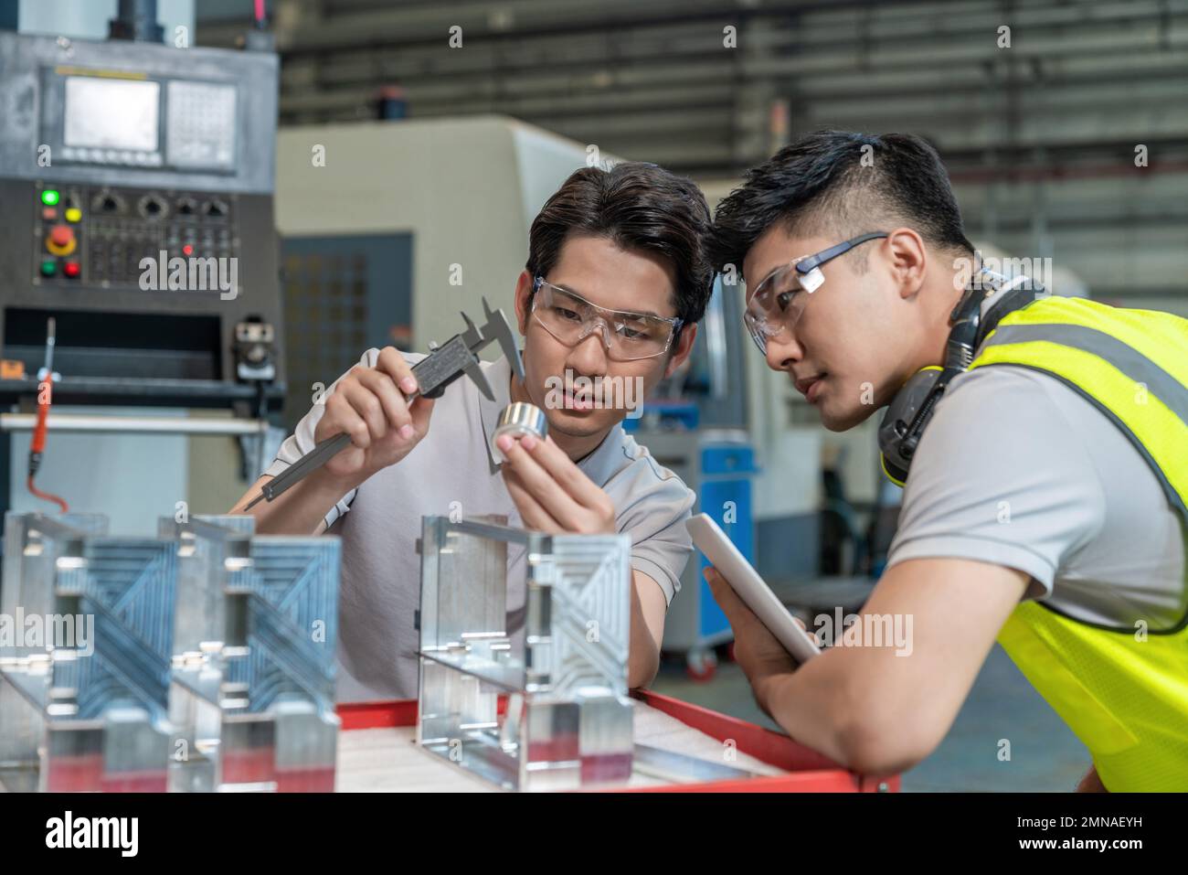 Two engineers at the factory to do measurement Stock Photo - Alamy