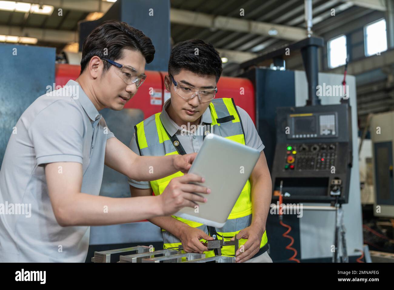Two engineers at the factory to do measurement Stock Photo - Alamy