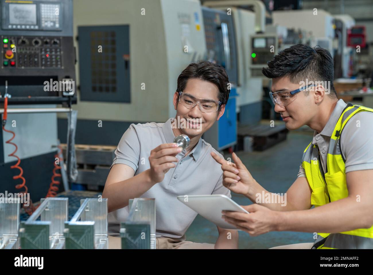 Two engineers at the factory to do measurement Stock Photo - Alamy