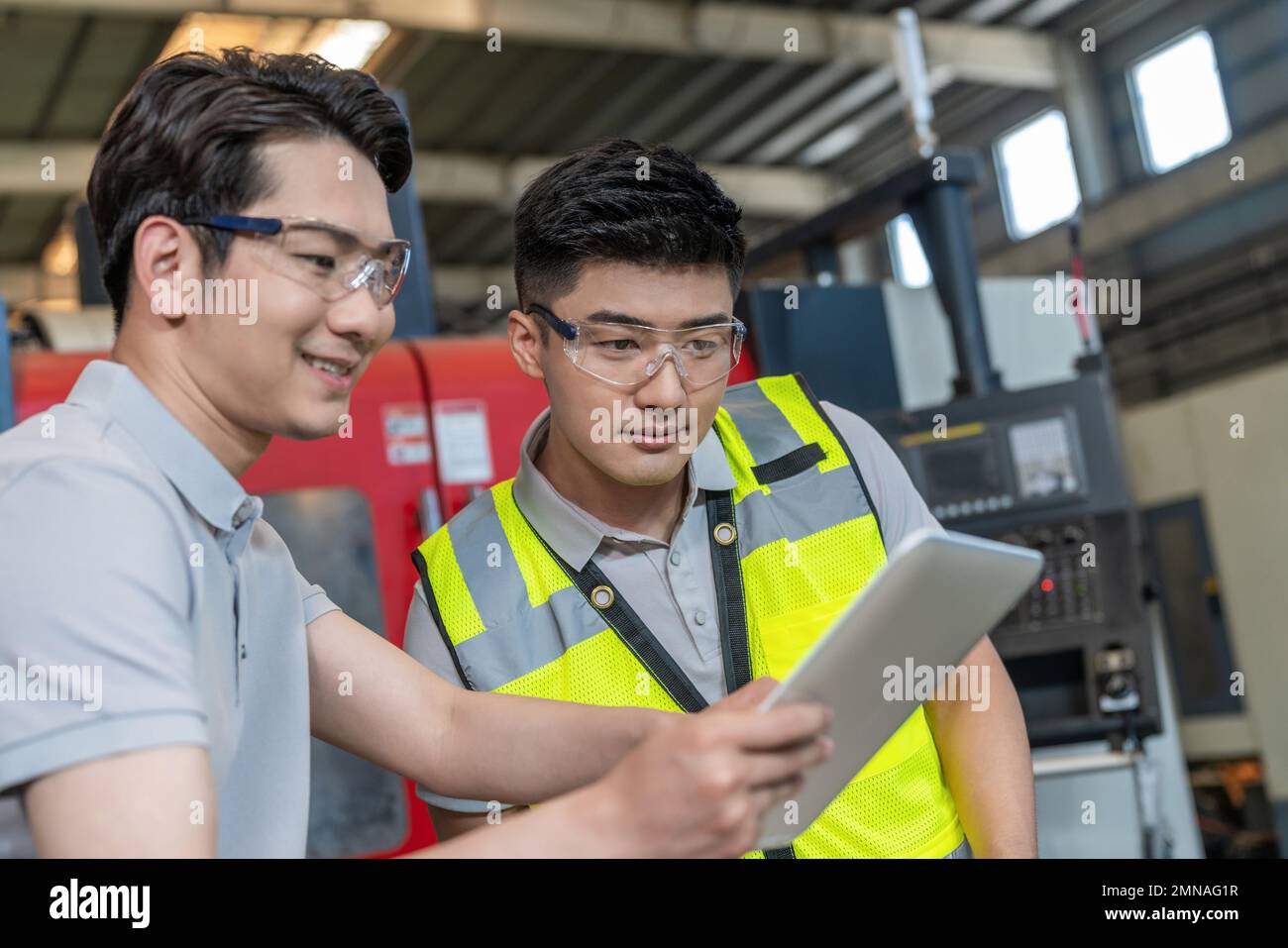 Two engineers at the factory to do measurement Stock Photo - Alamy