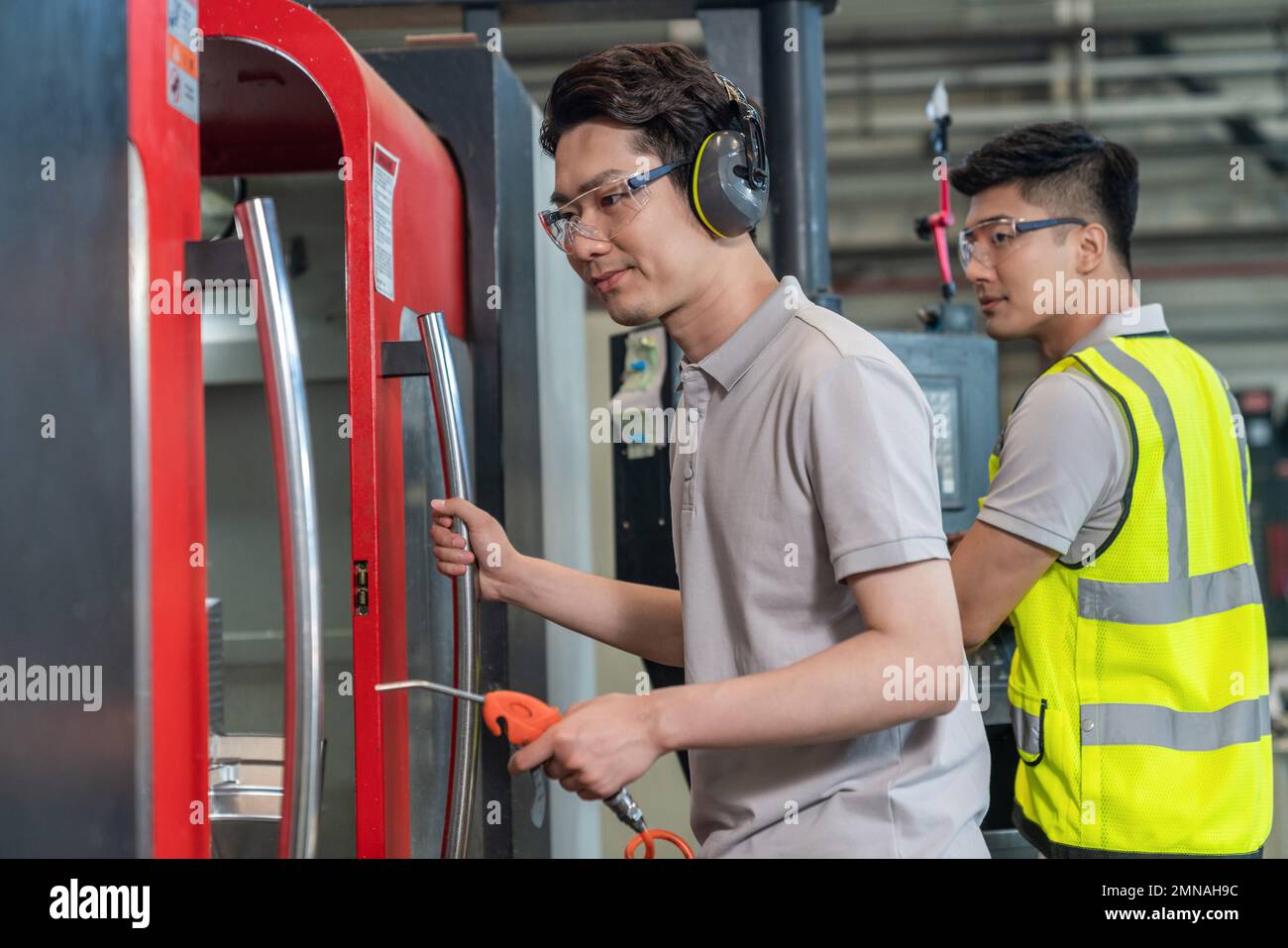 Two engineers working in the factory Stock Photo - Alamy