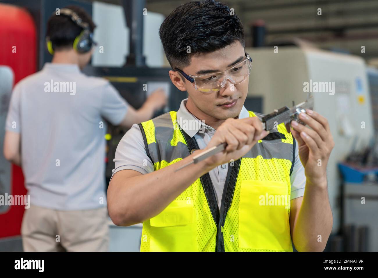 Two engineers working in the factory Stock Photo - Alamy